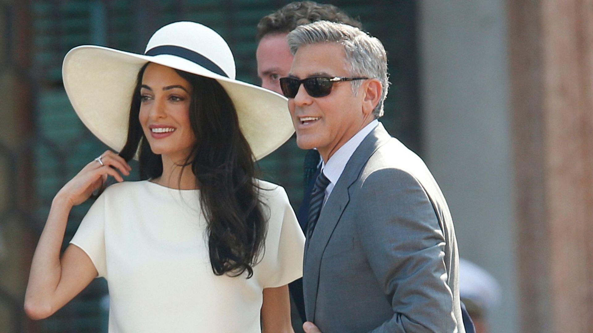 We're captivated by Amal Clooney's exquisite ivory and contrasting navy trim suit – it's a ...