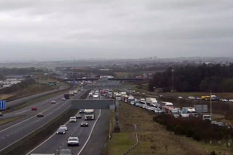 Hunt for 'man with potential weapon' as police seal off M8 junction in ...