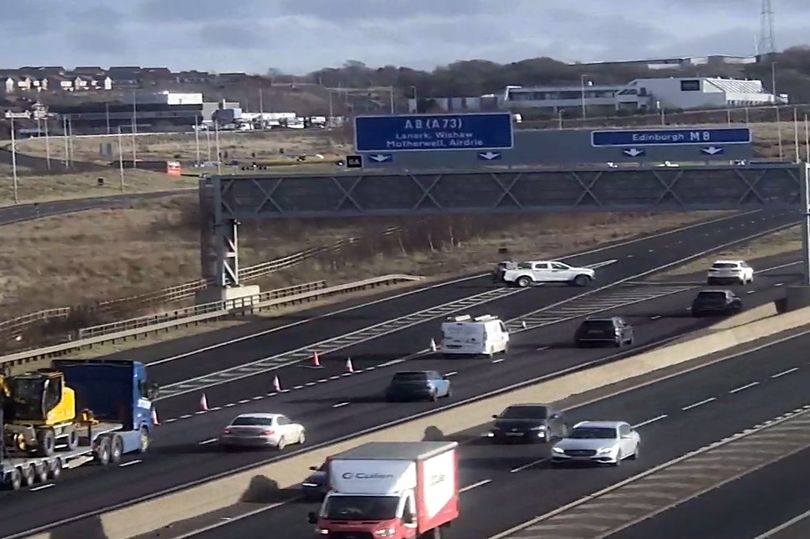 M8 junction remains shut off by police as search for 'man with weapon ...