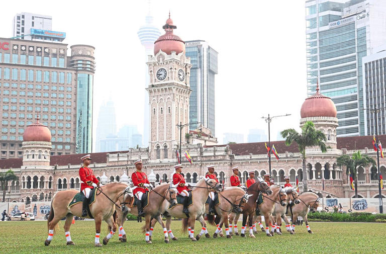 Raising flag, spirits in KL