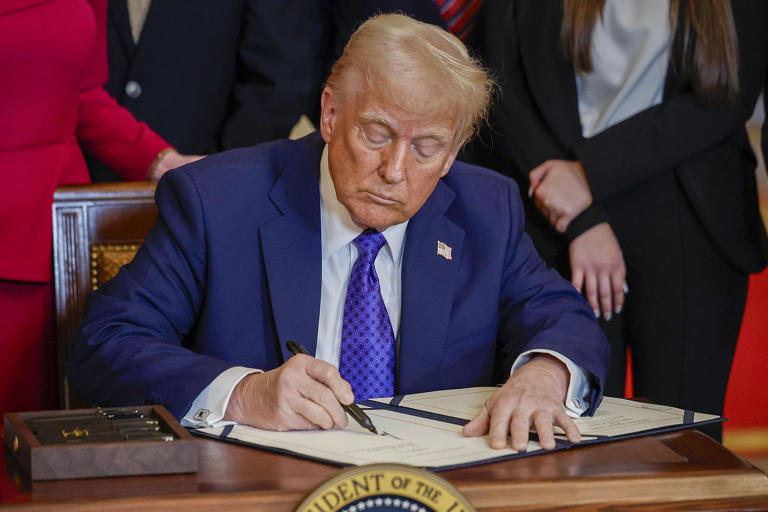 Trump signs few laws as he pushes to expand executive power