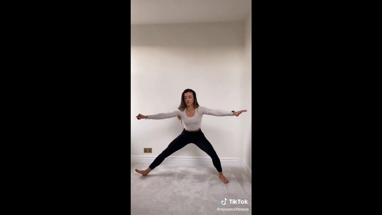 Doing Arms Exercise And Splitting