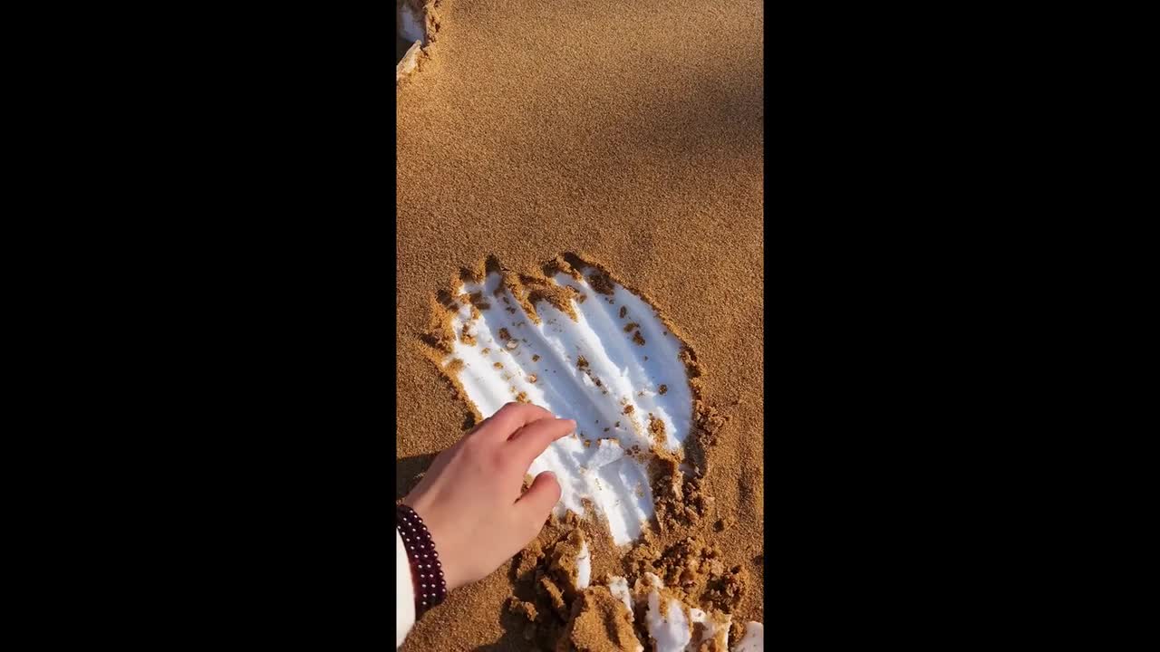 Beach in China resembles tiramisu as sand covers layers of snow after ...