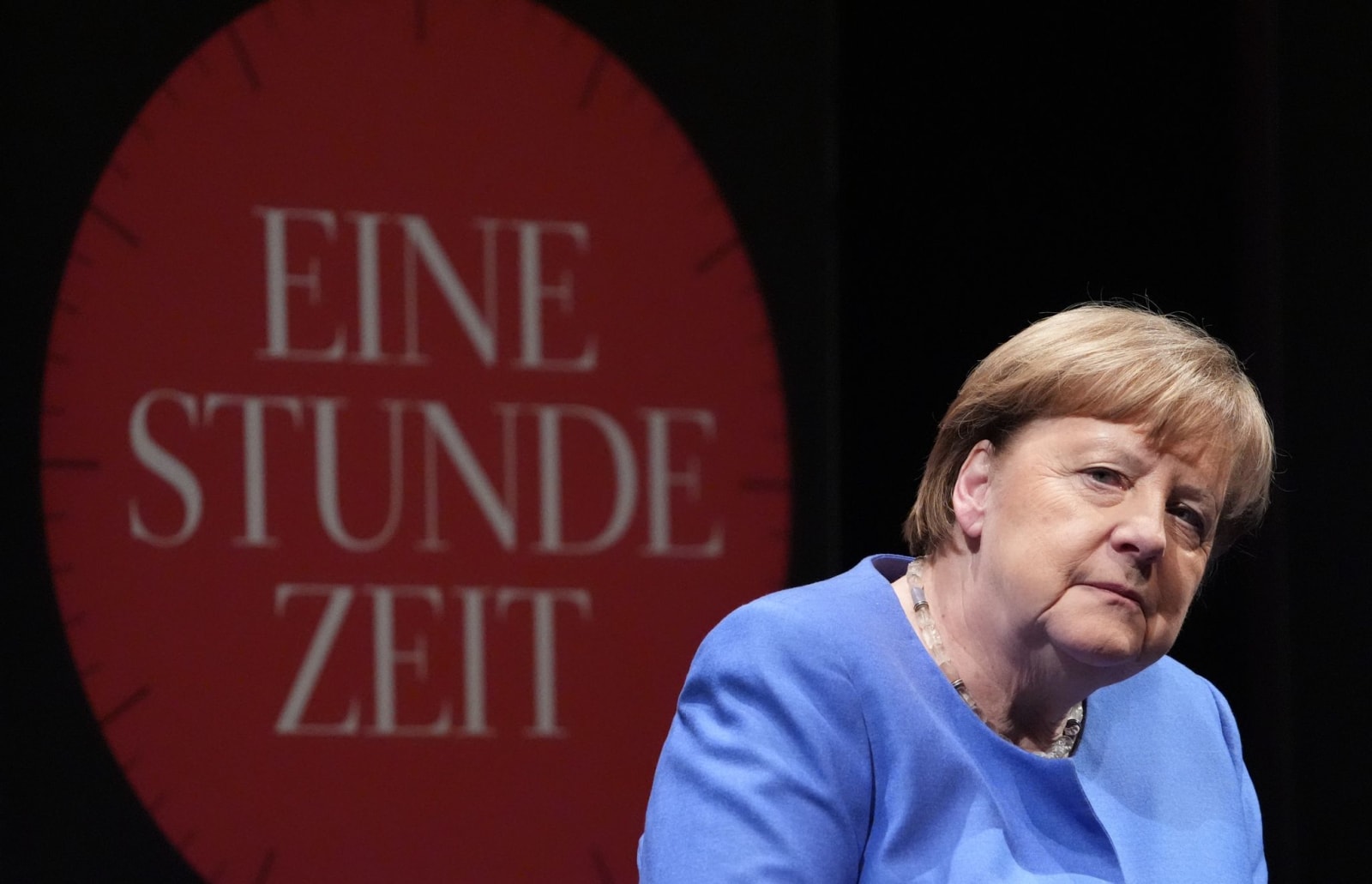 Germany's Merkel raises eyebrows with halting Merz endorsement