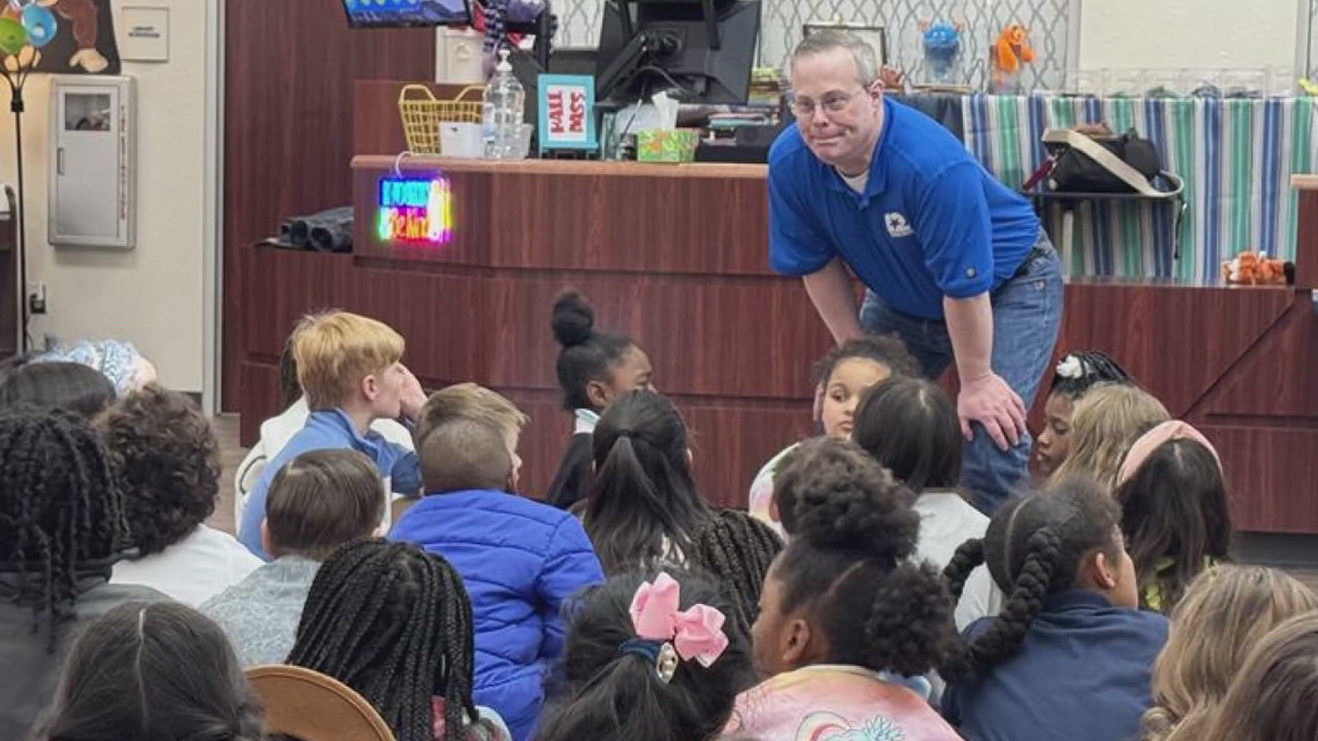 Patrick Vaughn speaks to curious kids at Sallie Curtis Elementary