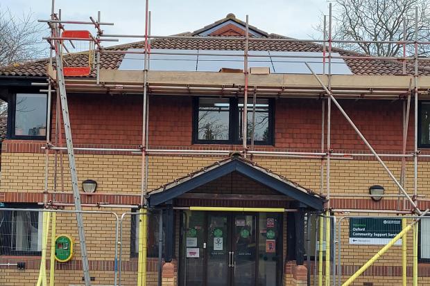 Scaffolding up at community building for solar panel works