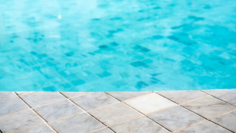 The Downside To Using Tile Around Your Pool (& Better Alternatives)