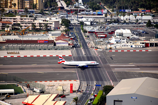 The airport where planes land on a runway crossing a main road