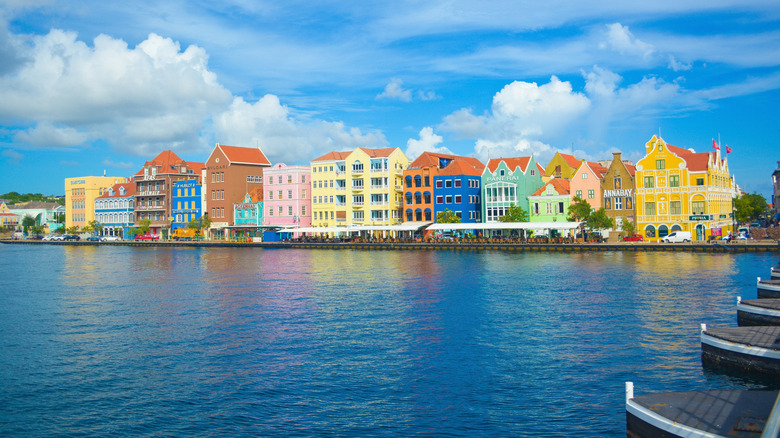 Colorful Buildings Line The Streets Of A Lively Curaçao Neighborhood ...