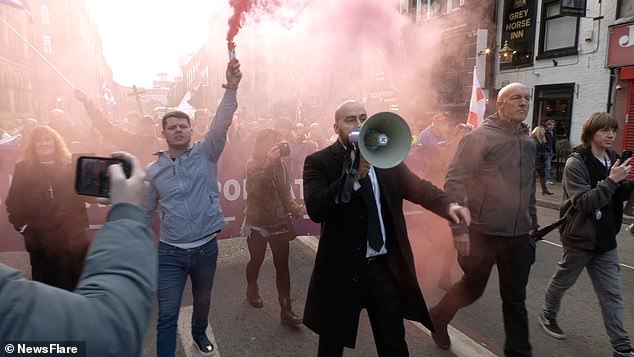 Moment protester flips cap off policeman's head at UKIP rally
