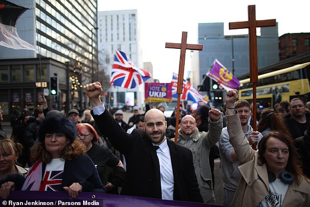 Moment protester flips cap off policeman's head at UKIP rally