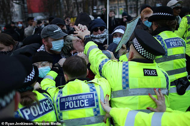 Moment protester flips cap off policeman's head at UKIP rally