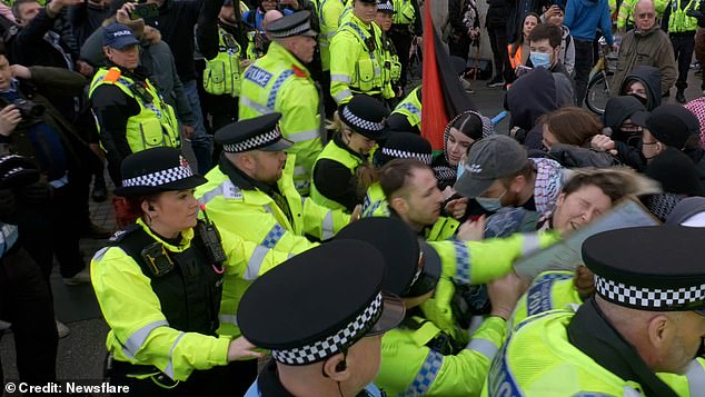 Moment protester flips cap off policeman's head at UKIP rally