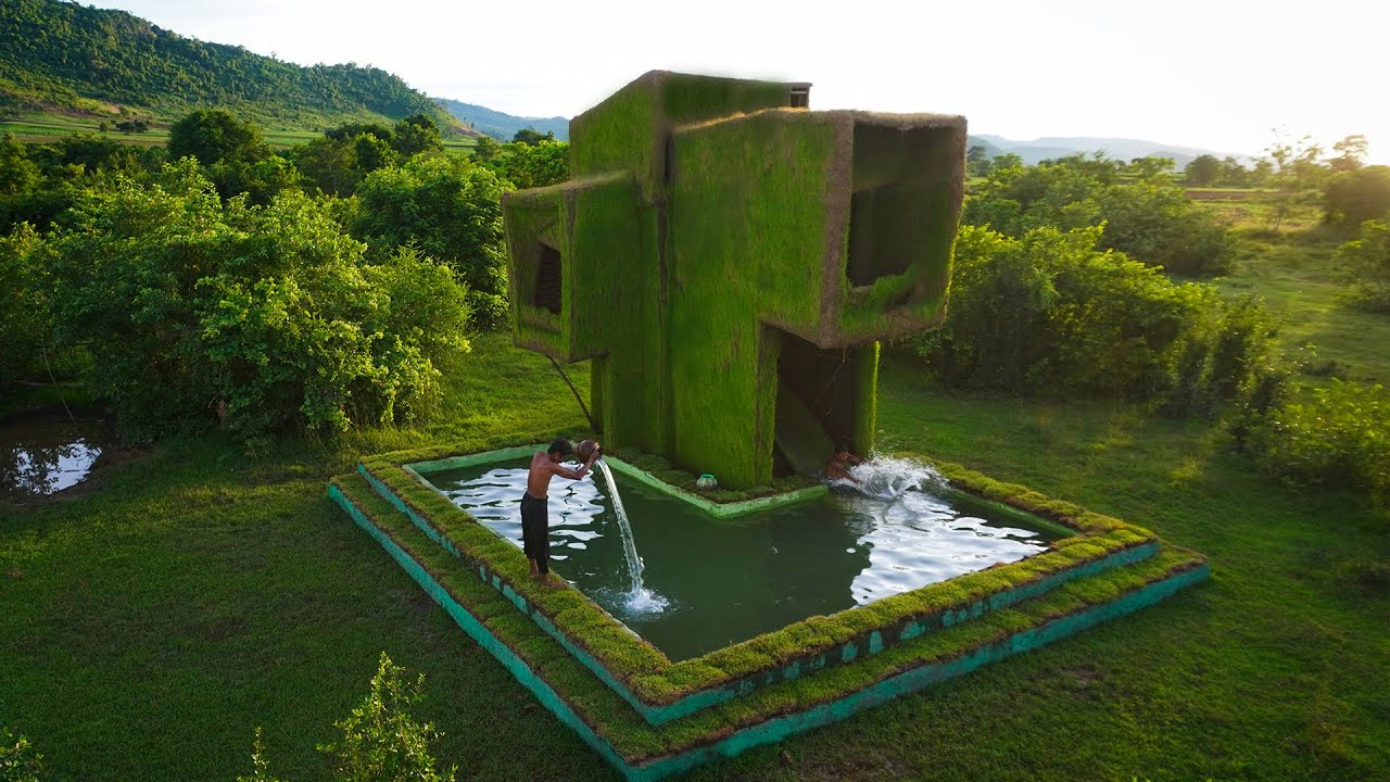 Eco-friendly mud house with rice plants and a pool slide built by hands ...