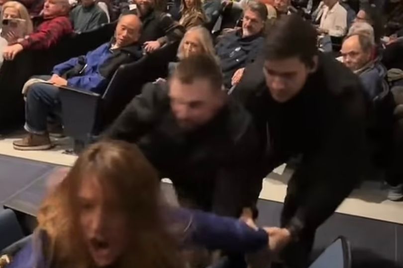 Idaho town hall meeting turns into brawl as a heckling woman is dragged out