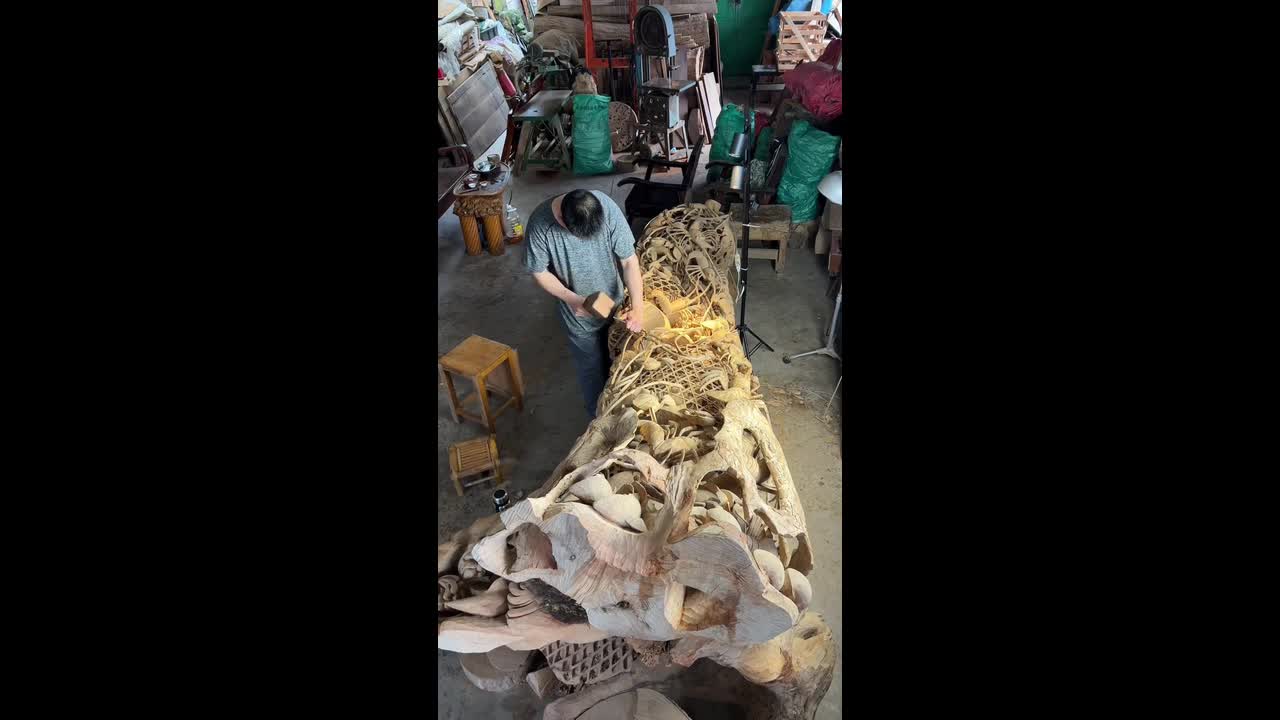 Chinese craftsman creates intricate giant wood carving