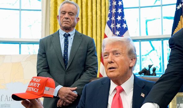 RFK Jr seethes in background as Donald Trump peddles new MAGA merch ...