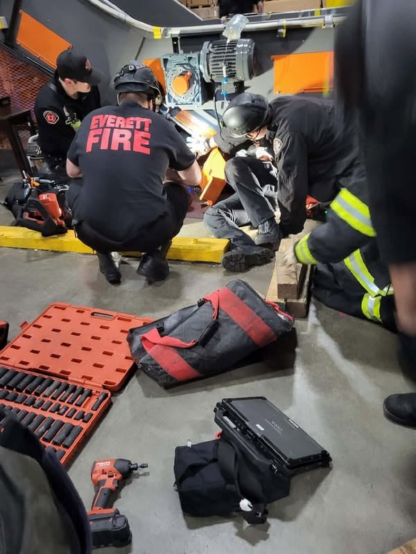 Goodwill worker rescued after getting arm trapped in baler machine in ...