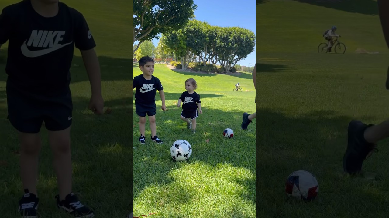 Adorable family enjoys playing soccer together at the park