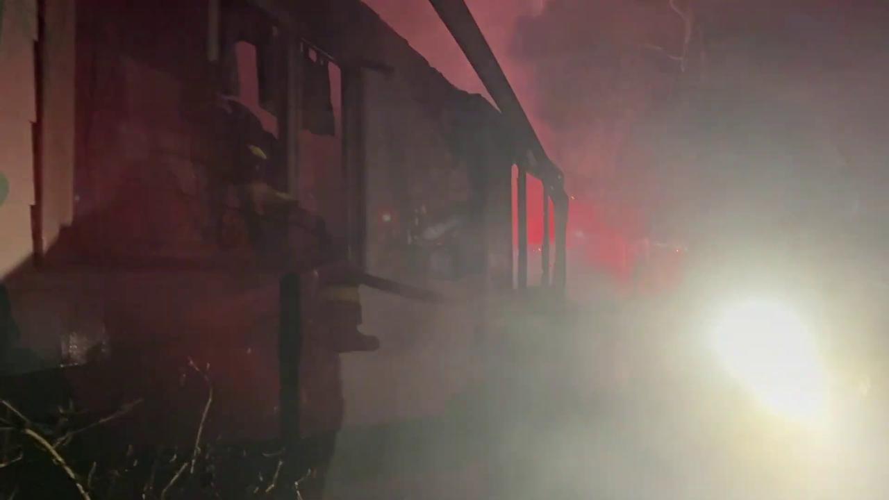 Firefighters save woman, 84, moments before house roof collapses in blaze