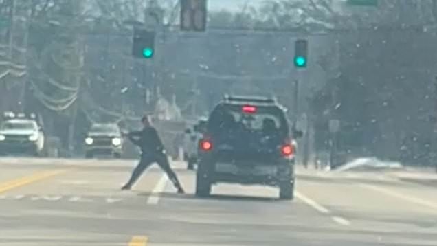 Shocking moment axe-wielding man attacks car in broad daylight