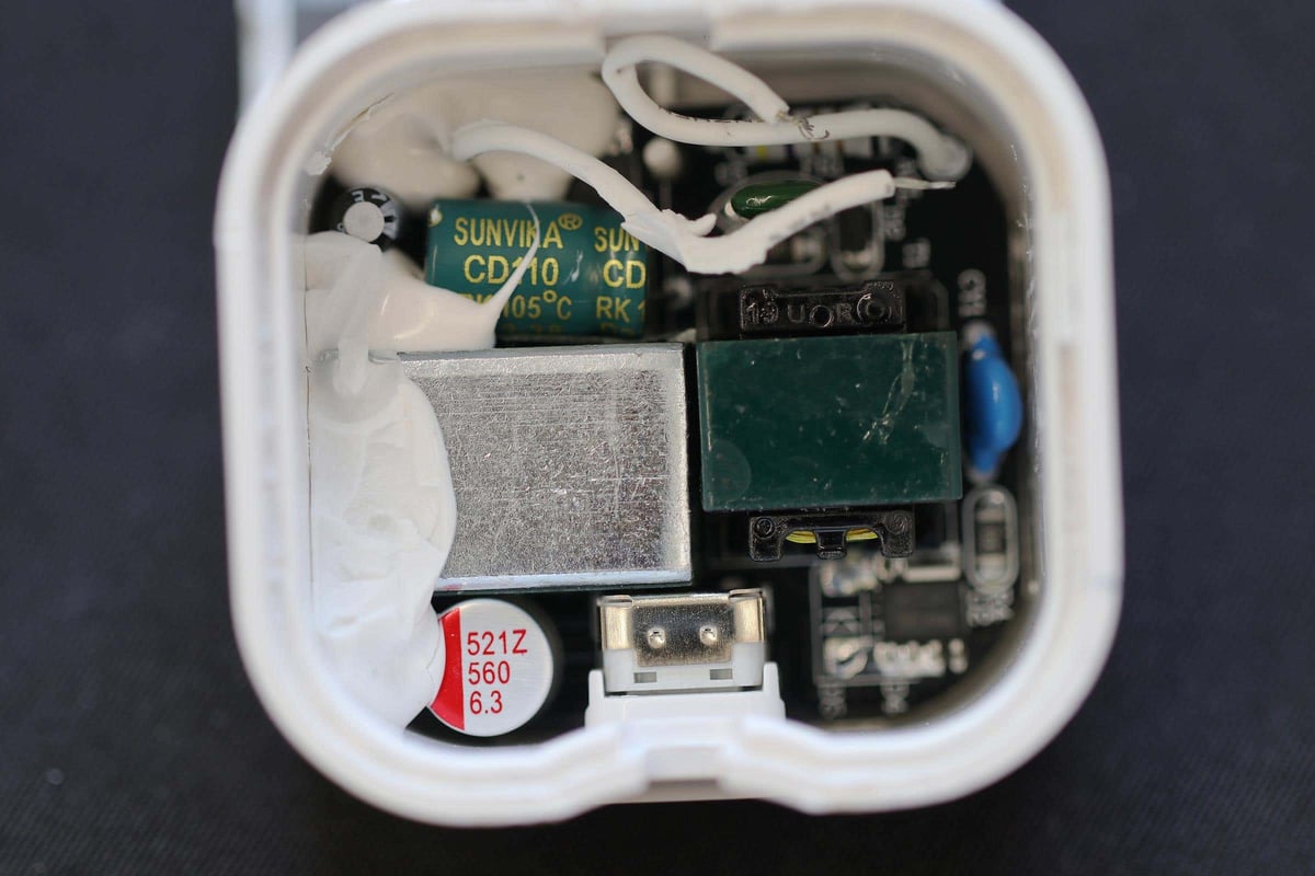 Counterfeiters adding metal weights to fake Apple power adapters to ...