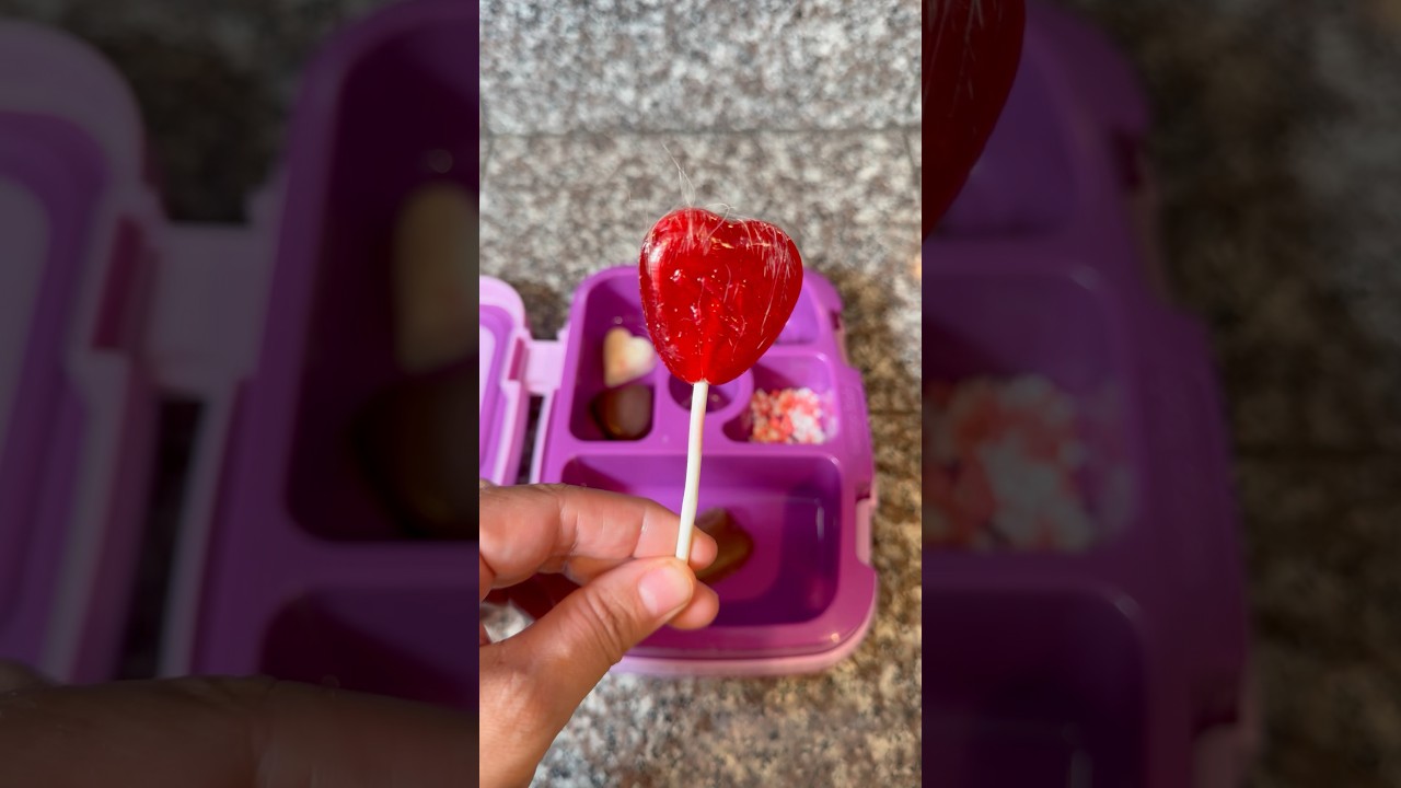 Packing school lunch with heart-shaped peanut butter sandwich