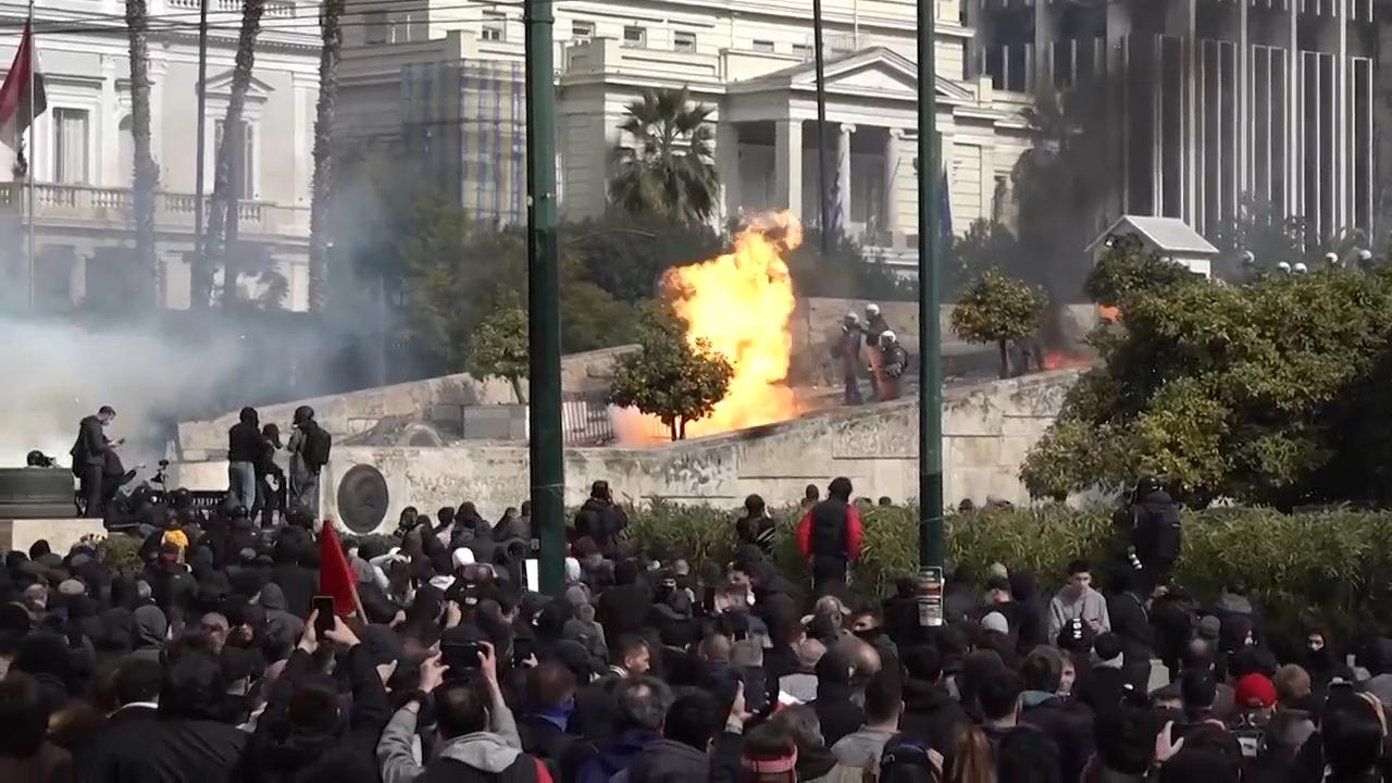 Protesters and police clash in Athens on deadly train crash anniversary