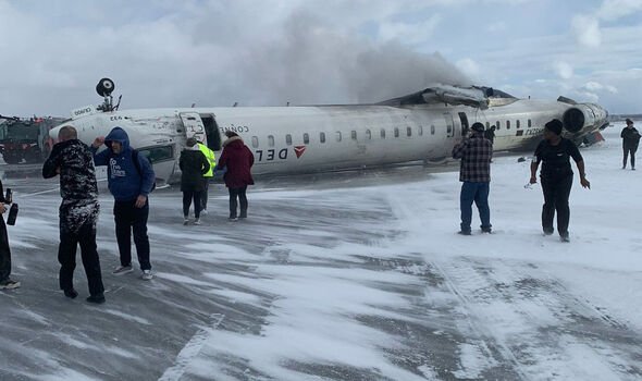 Delta plane crash: Terrifying images show aircraft upside down at ...