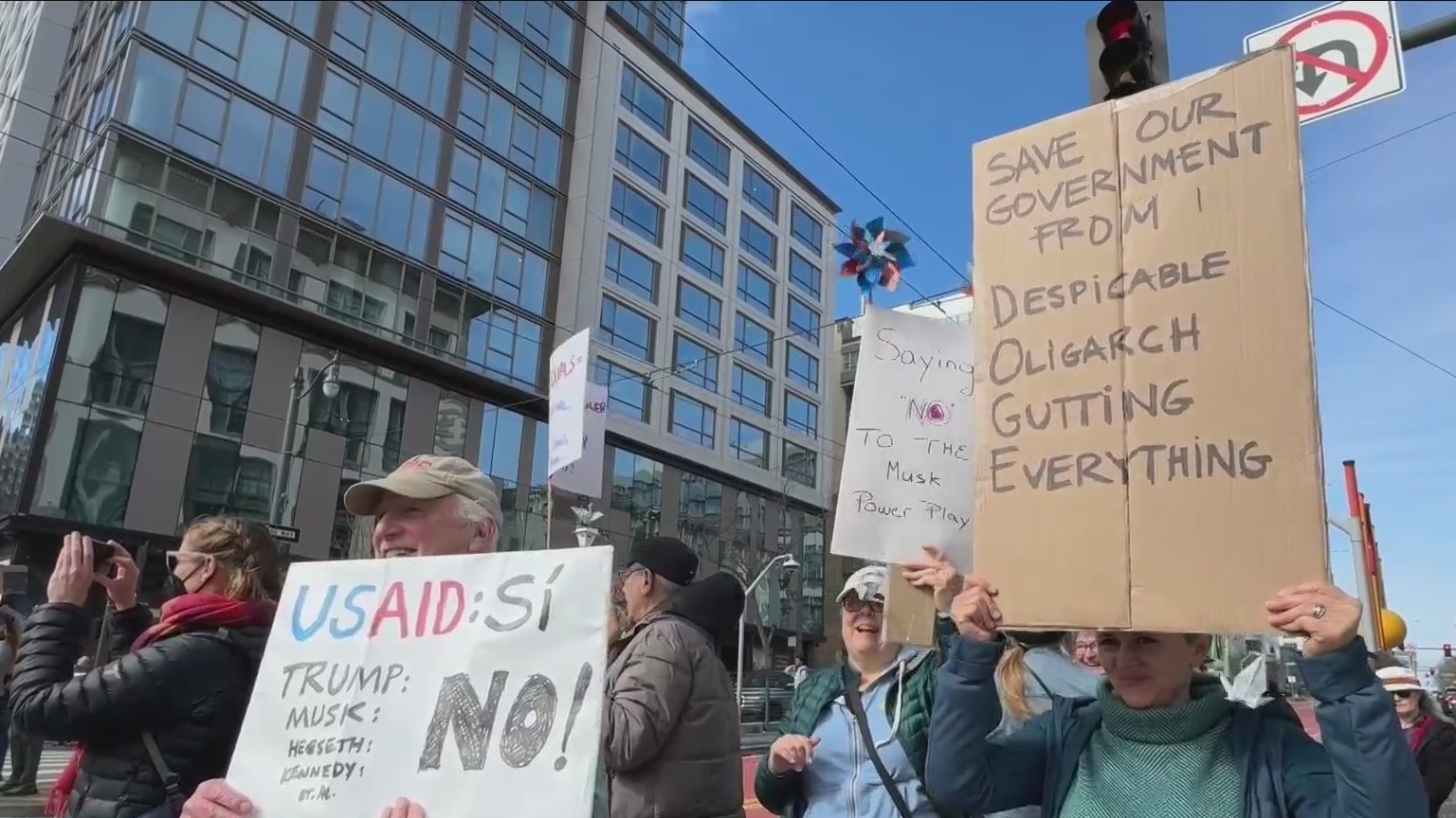 Protesters march against Trump administration, DOGE cuts on Presidents Day