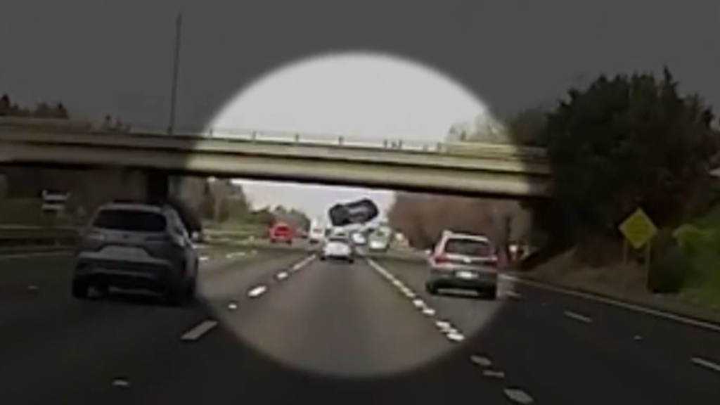 Dashcam video shows car flying off US overpass onto highway
