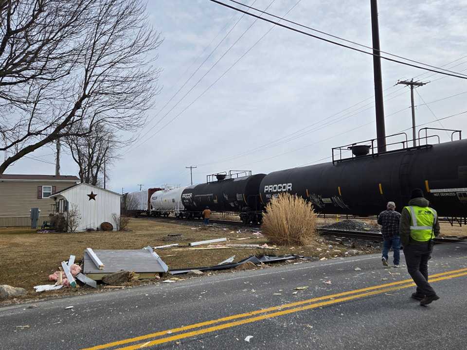 Train hits mobile home being hauled by truck