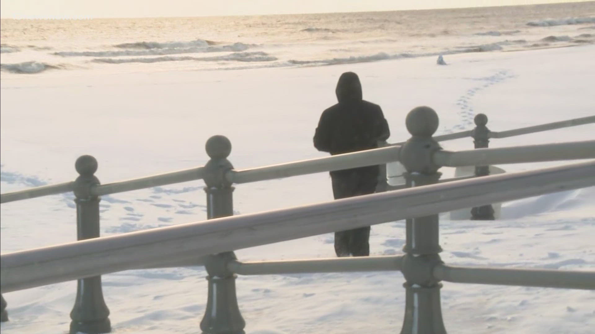 Sun rises over snow-covered Virginia Beach boardwalk