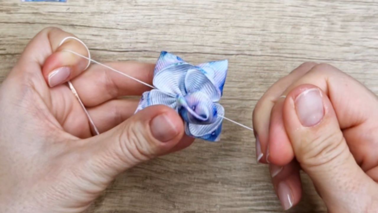 Artist creates ribbon flowers from flowery ribbon tape
