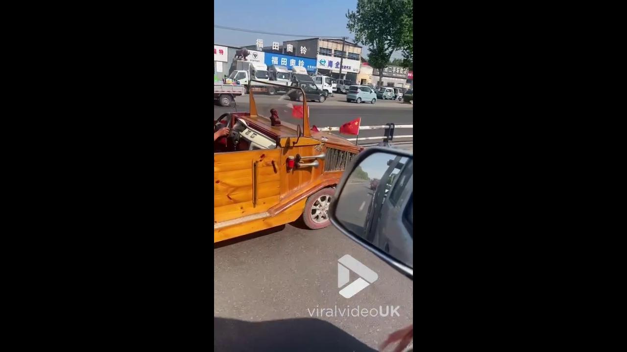 VV4914 Grandpa driving a homemade classic car on the road