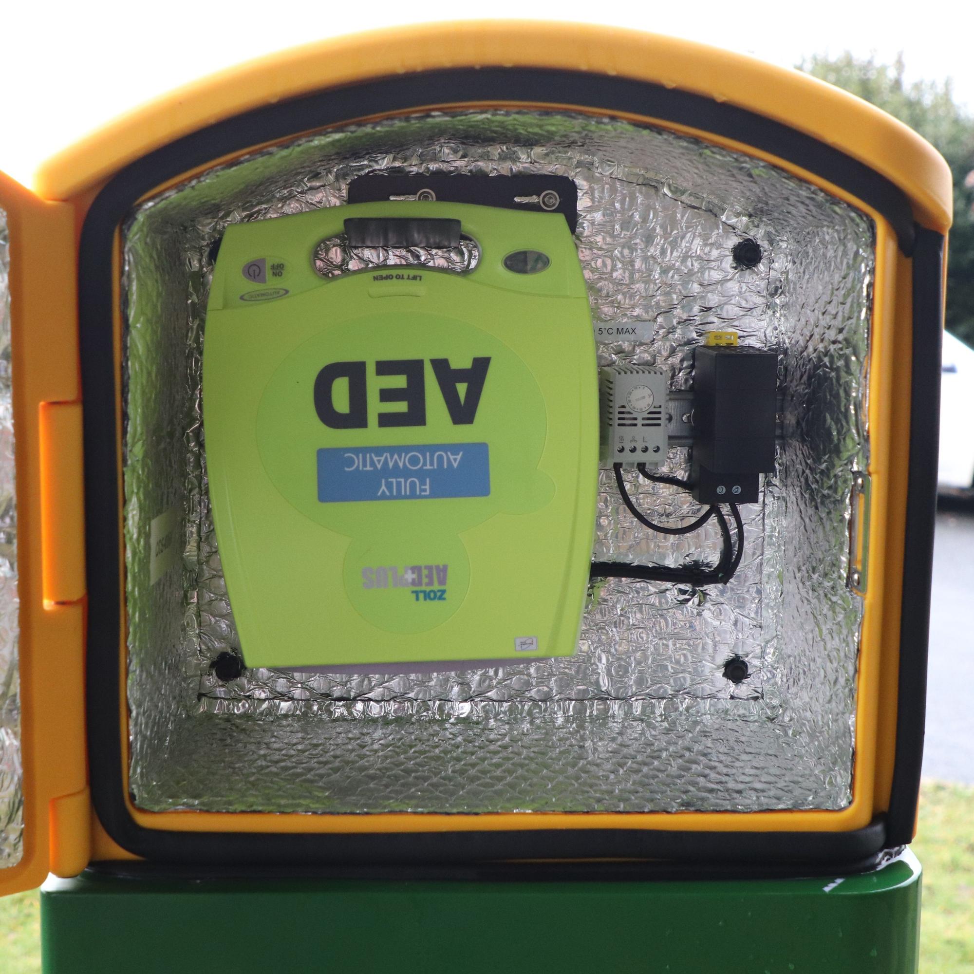 A solar power defibrillator is handed over in Bishopstone