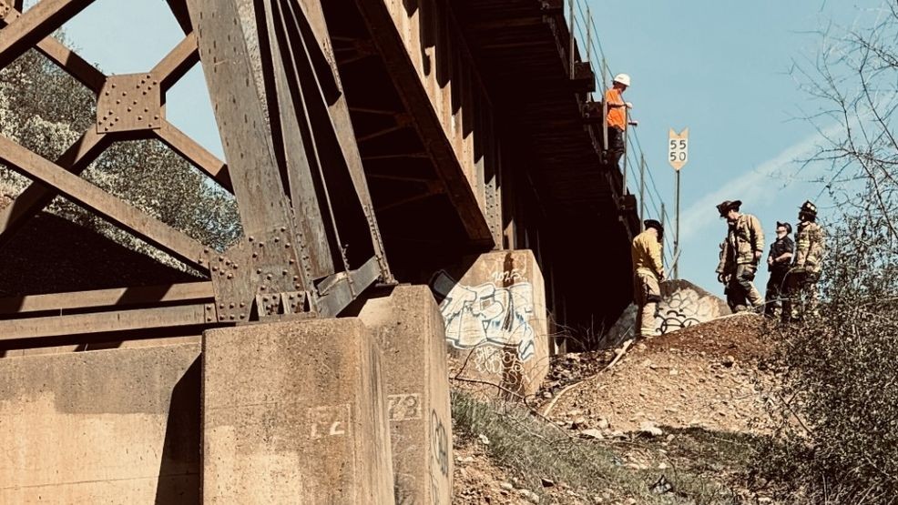 Fire crews contain vegetation fire under train trestle in Redding