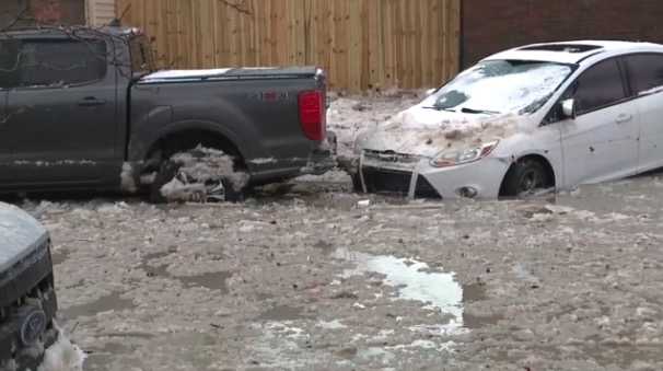 Streets of Detroit lined with frozen cars after major flooding