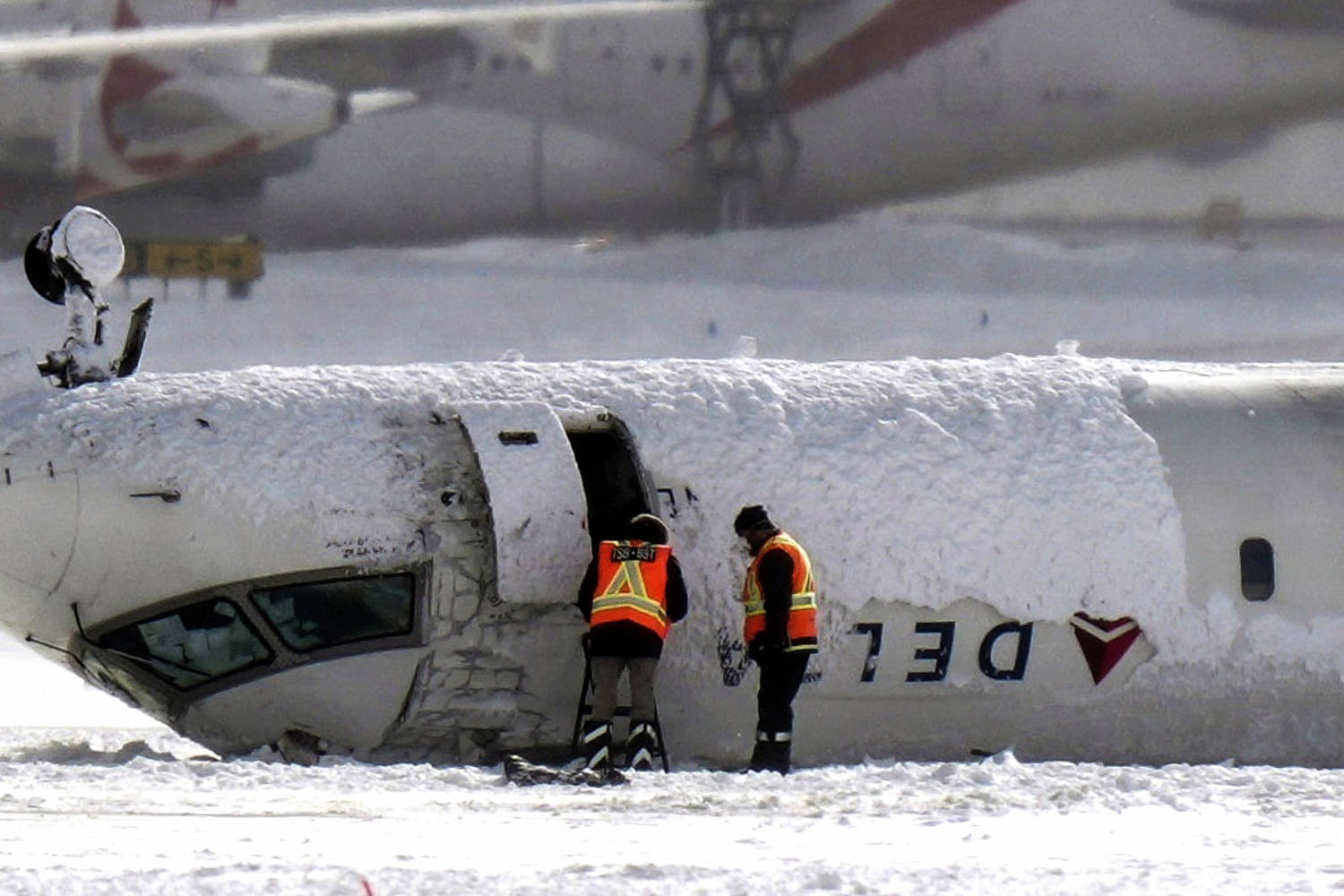 Two passengers sue Delta after plane rolls over during crash-landing in ...