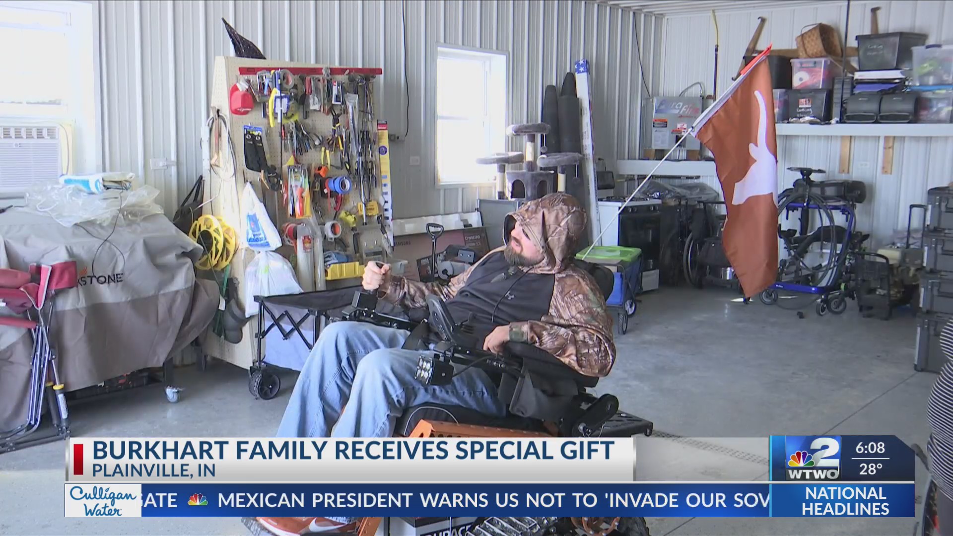 Travis Burkhart and family receive an Action Track Chair from local farmers