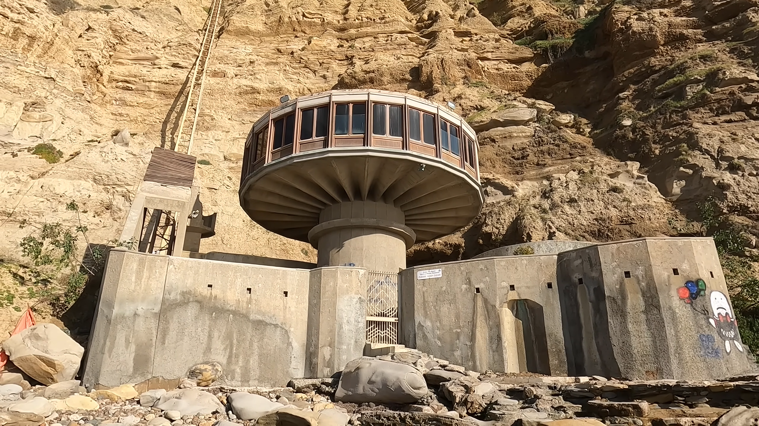 Built for luxury, now left alone on the edge of the ocean