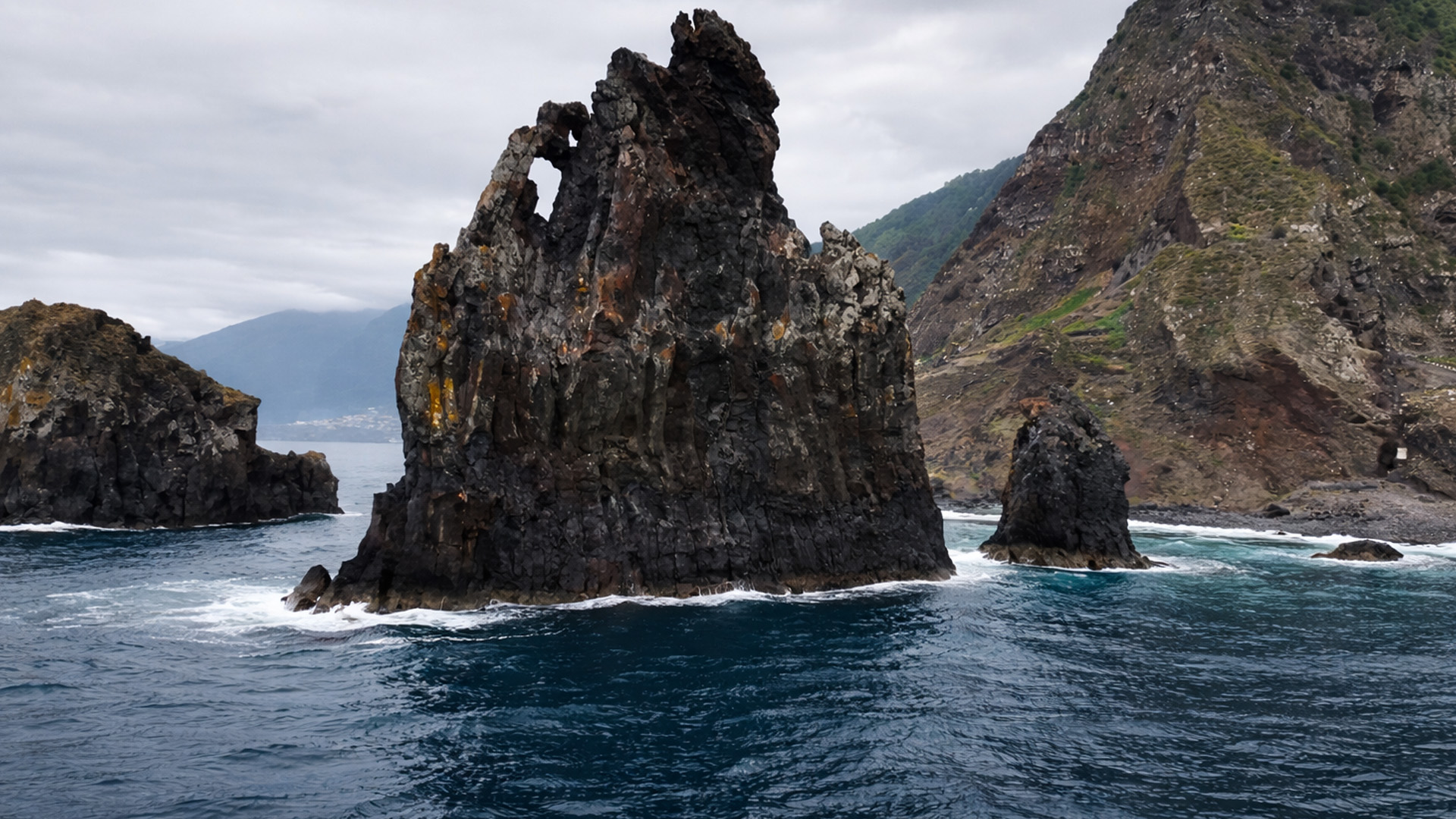 Jagged sea cliffs rising from deep waters