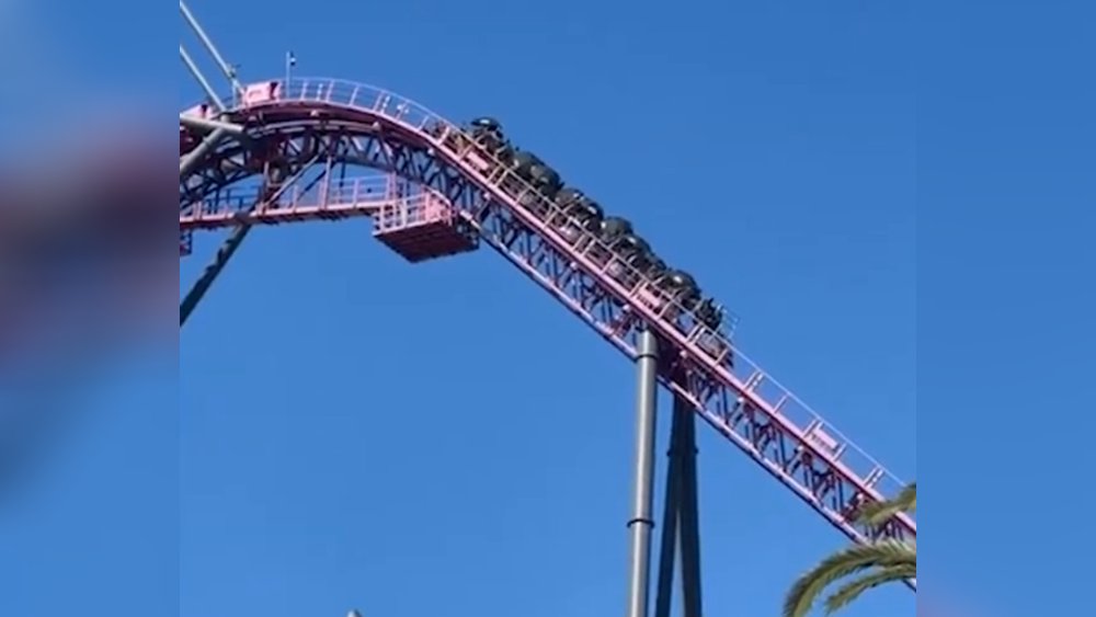 Roller coaster riders are stranded 50 meters above the ground