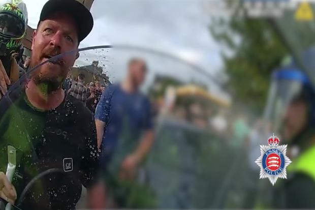 Watch as two jailed men clash with police in 'violent' Essex protest