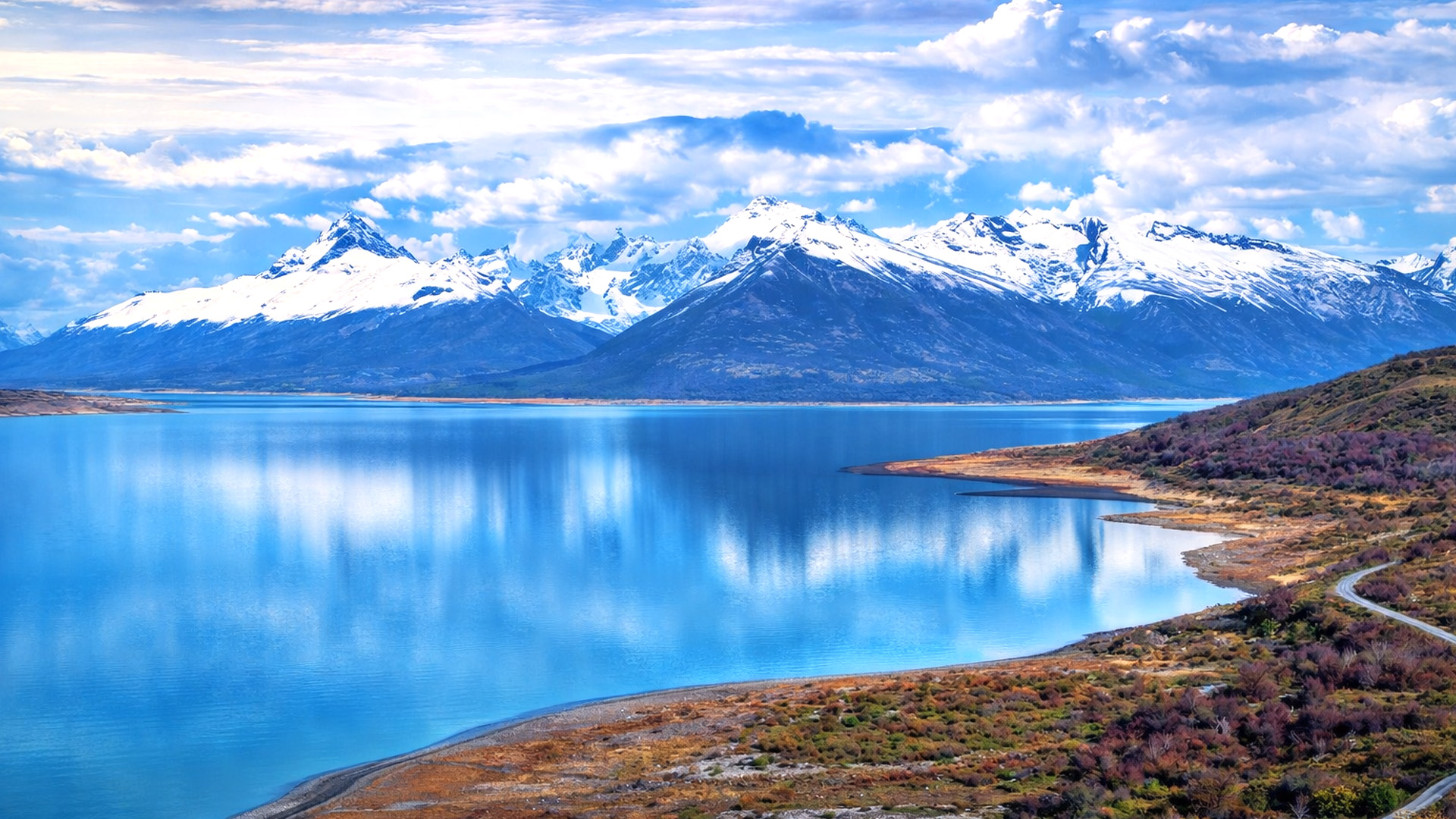 Where snowy mountains drop straight into a deep blue lake