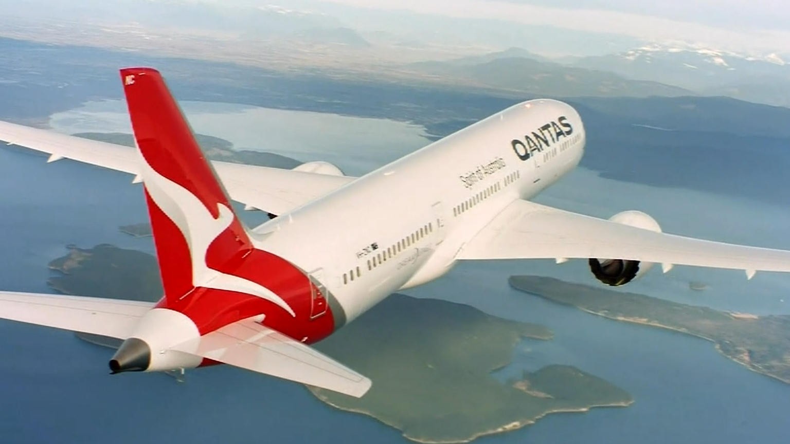 Woman dies mid-air on Qantas flight