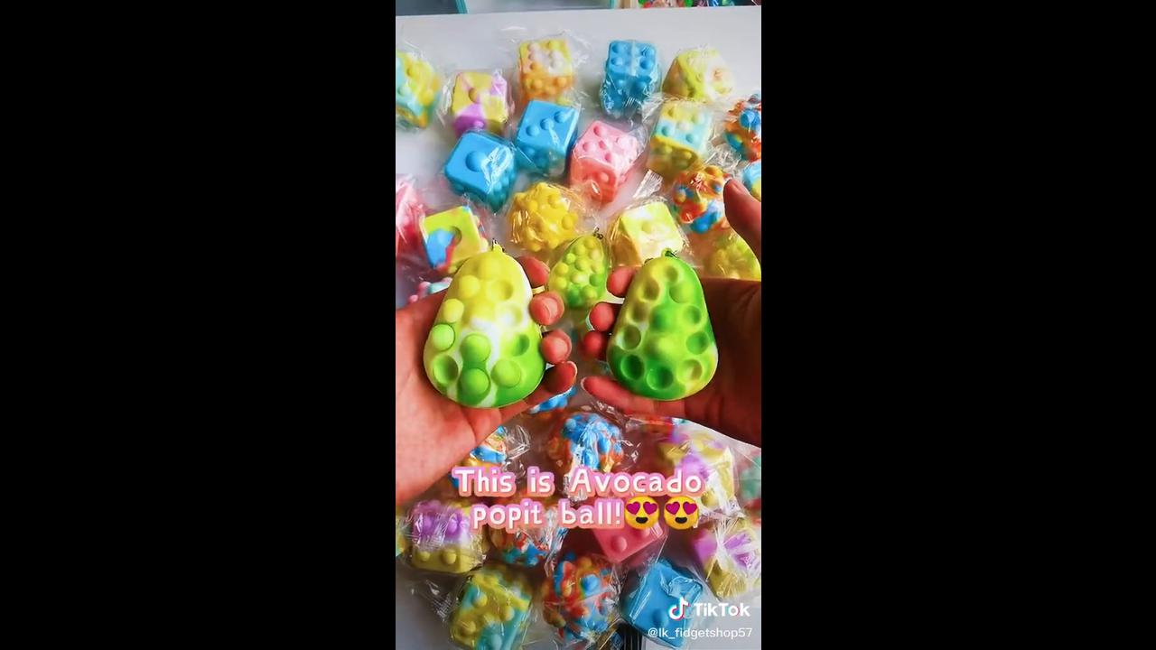 Squeezing colorful avocado pop it balls with soft silicone texture for ...
