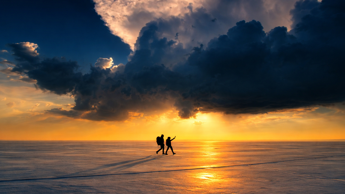 Quiet journey on frozen land beneath heavy evening clouds