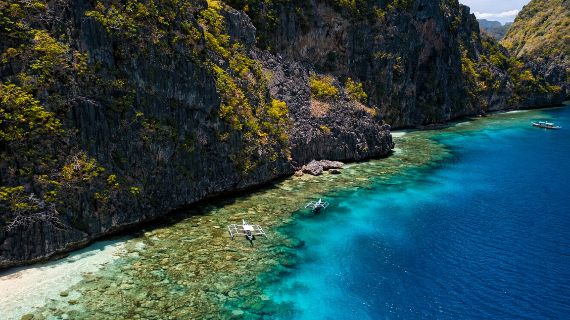 Hidden lagoon with clear blue water along rugged cliffs