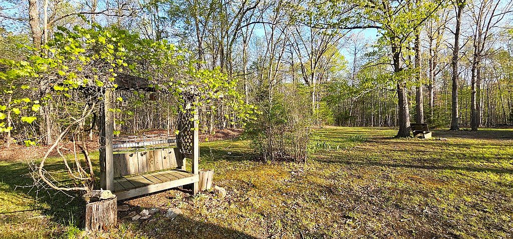 1979 log cabin in Skipwith, Virginia, featuring expansive wood ...